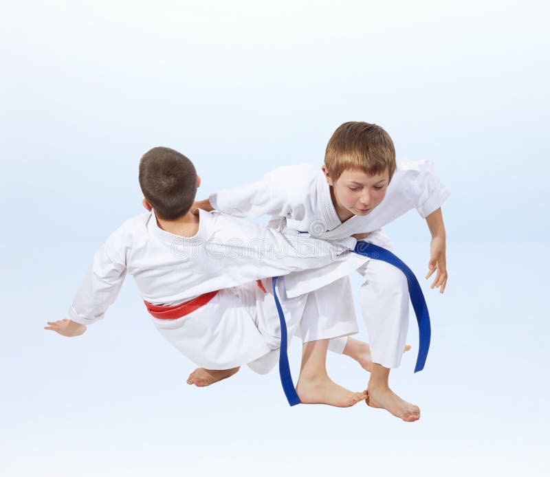 A Boy with a Blue Belt and a Cap of Santa Claus Hits a Kick Leg Stock ...