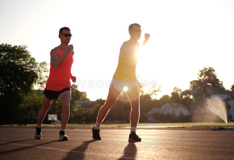 Two Athletes Compete in Running at the Stadium Stock Photo - Image of ...
