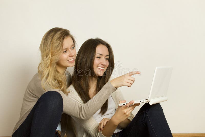 Happy Friends Using Laptop and Talking at Home Stock Photo - Image of ...