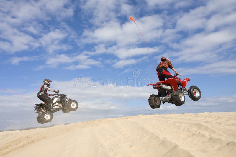 Two atv jumpers stock image. Image of leisure, clouds - 13192247