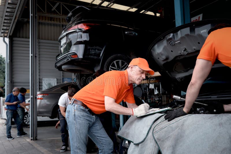 Two Cheerful Happy Auto Mechanic Worker Men Giving Touching Hands and ...