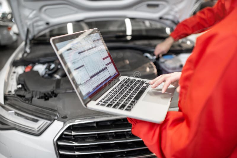 Auto Mechanics Doing Diagnostics with Laptop Stock Image - Image of ...
