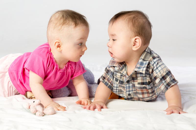 Two Babies Look at Each Other in Studio with Stock Photo - Image of ...
