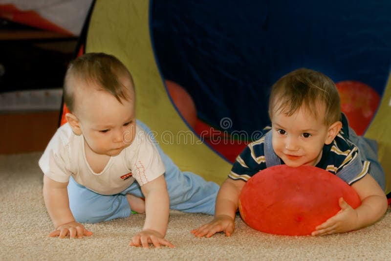Two babies playing indoors stock photo. Image of family - 6059378
