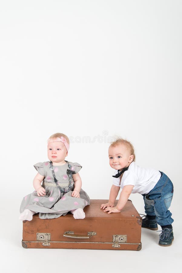 Two Babies with the Suitcase Stock Photo - Image of months, jeans: 30017392