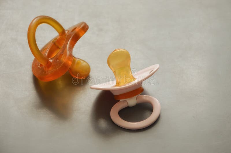 Two Baby Pacifier Dummy on a Gray Table for Feeding Stock Photo - Image ...