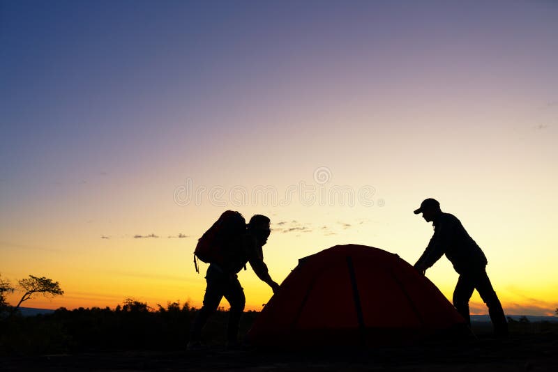 Two Backpacker Help Hold Tent in Camping Trip on the Hill Stock Photo ...