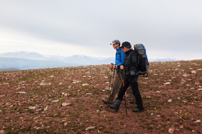 Two Backpackers in Mountains Stock Image - Image of carrying, mountains ...