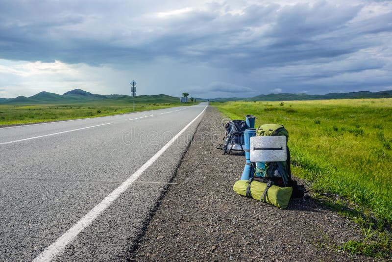 Two Backpacks by the Side of the Road Stock Photo - Image of back ...
