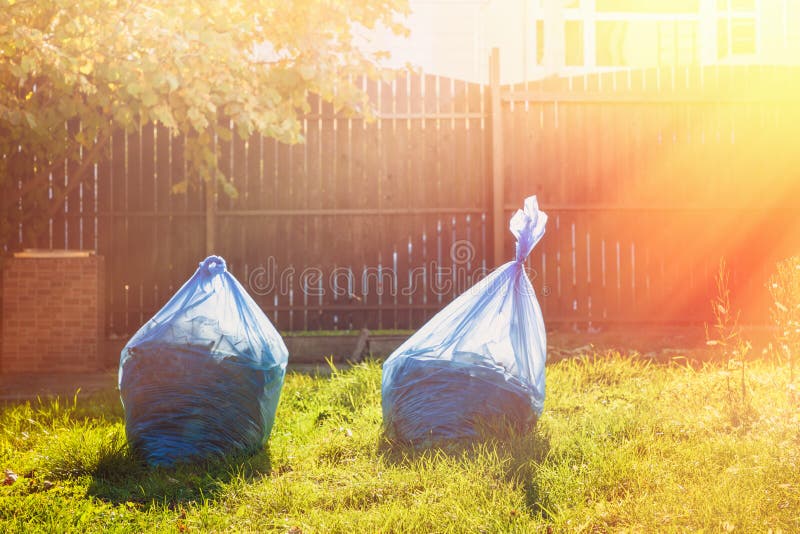 Two Bags of Compost on the Grass in the Sun at Sunset Stock Photo ...