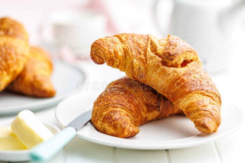 Two Baked Tasty Croissants on Plate on White Table Stock Photo - Image ...