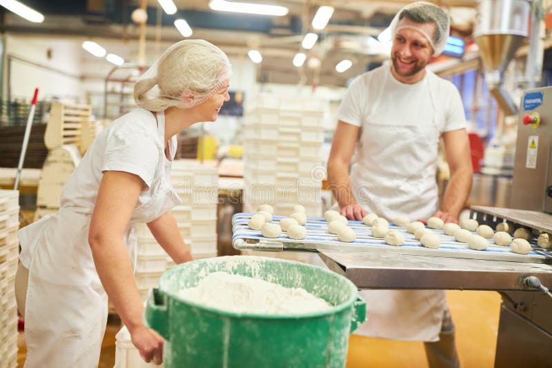 Two Bakers Bake Buns Together at the Belt Proofer Stock Image - Image ...