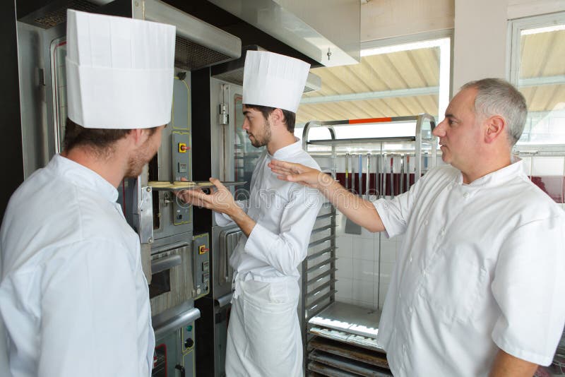 Two Bakers in Bakery or Bakehouse Baking Pretzels Stock Photo - Image ...