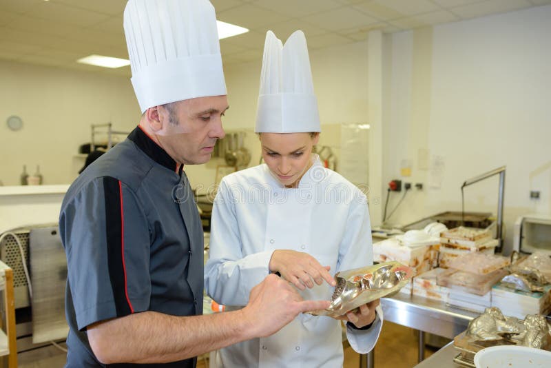 Two Bakers Talking in Kitchen Stock Photo - Image of kitchen ...