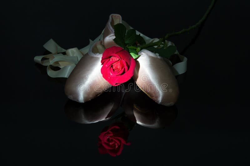 Two Ballet Slippers and Red Rose on Black Stock Image - Image of floor ...