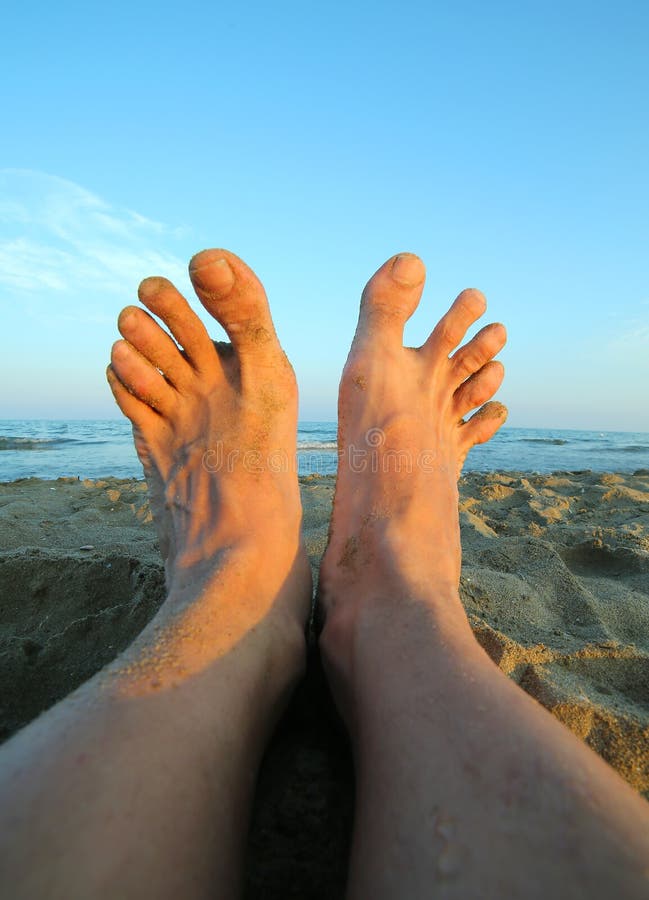 Two Bare Feet of a Man at Sunset Stock Image - Image of hallux, water ...