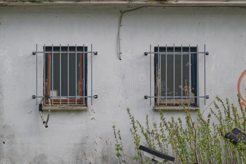 Barred Windows on a Weathered Wall Stock Photo - Image of urban, jail ...