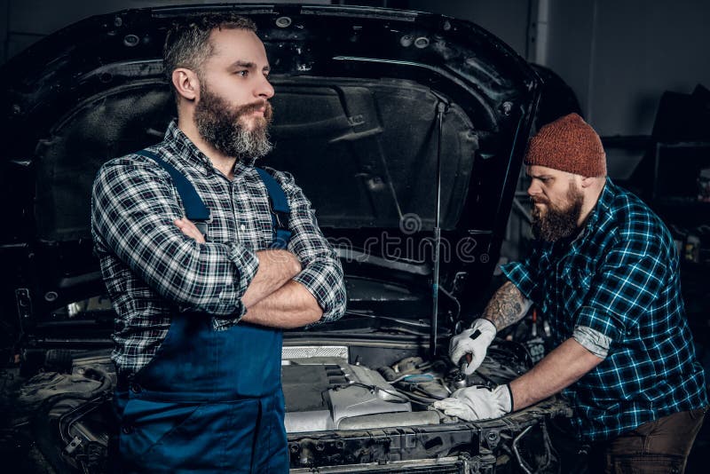 Two men in a garage. stock photo. Image of urban, individuality - 109911050