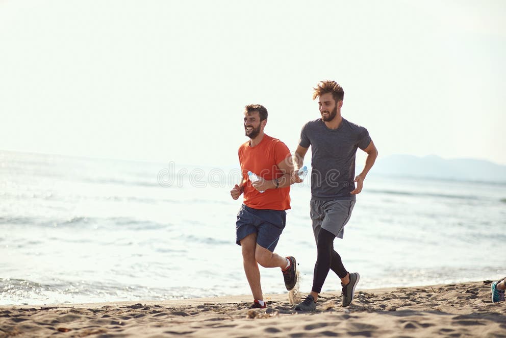 Two Guys Running Along the Beach Coast Stock Image - Image of adult ...