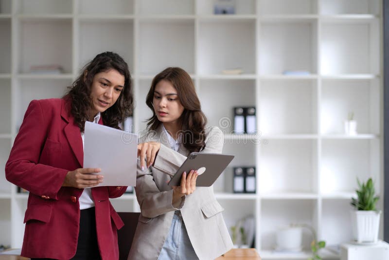 Two Beautiful Asian Businesswomen Standing Using Digital Tablet ...
