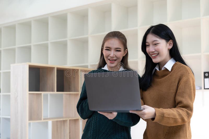 Two Beautiful Asian Businesswomen Standing Using Digital Tablet ...