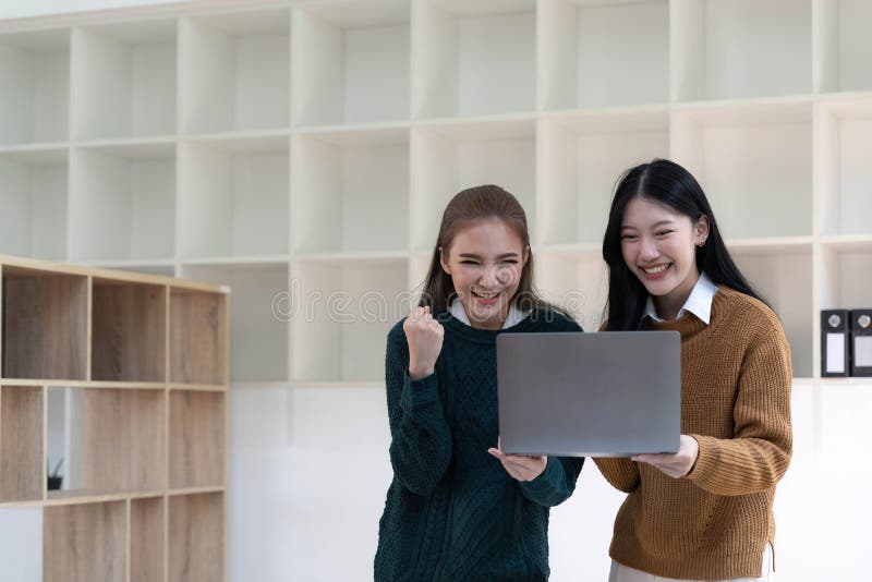 Two Beautiful Asian Businesswomen Standing Using Digital Tablet ...