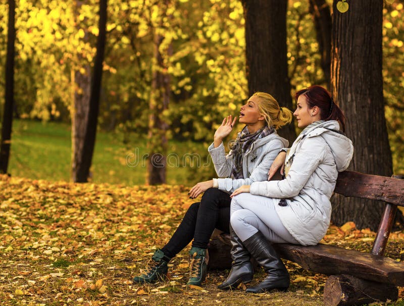 Two Beautiful Female Friends Resting on Bench in Park Stock Photo ...