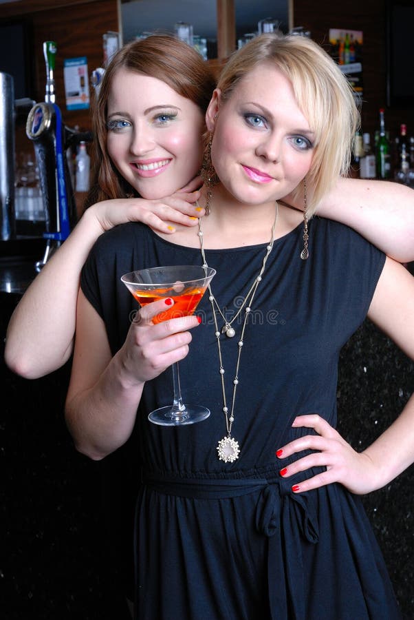 Two beautiful girls in bar stock photo. Image of pose - 16554802