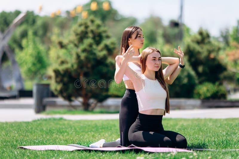 Two Beautiful Girls Do Exercises Outdoors in the Park Stock Image ...