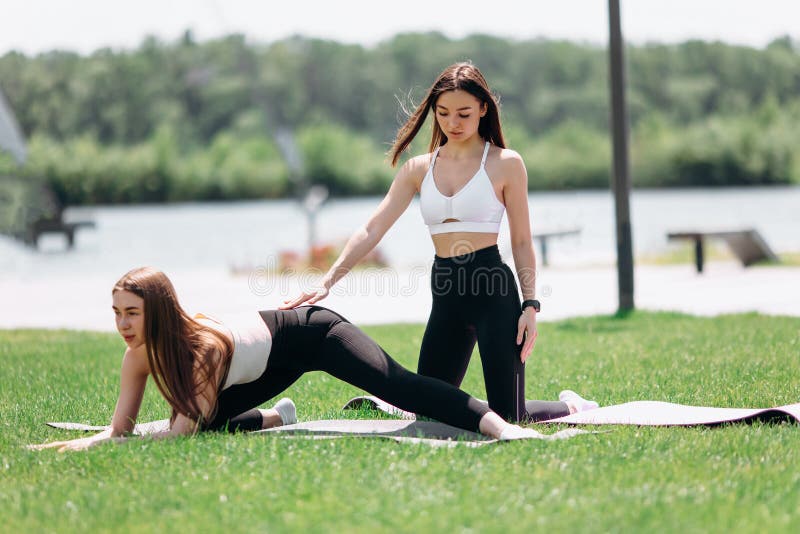 Two Beautiful Girls Do Exercises Outdoors in the Park Stock Image ...