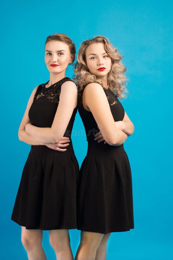 Two Beautiful Girls in the Same Black Dress Stock Photo - Image of pose ...