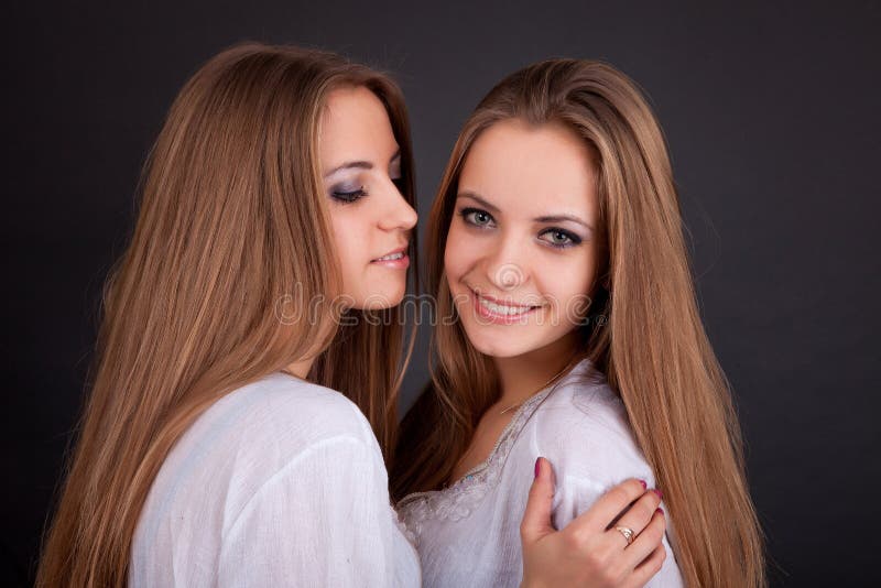 Two Beautiful Girls Twins, Isolated on Black Stock Photo - Image of ...