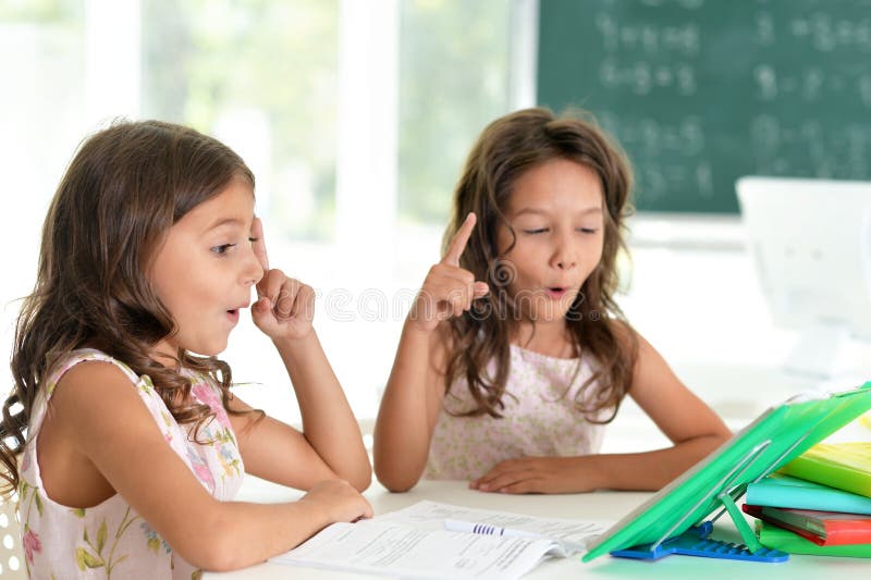 Portrait of Two Beautiful Little Girls Studying Stock Photo - Image of ...