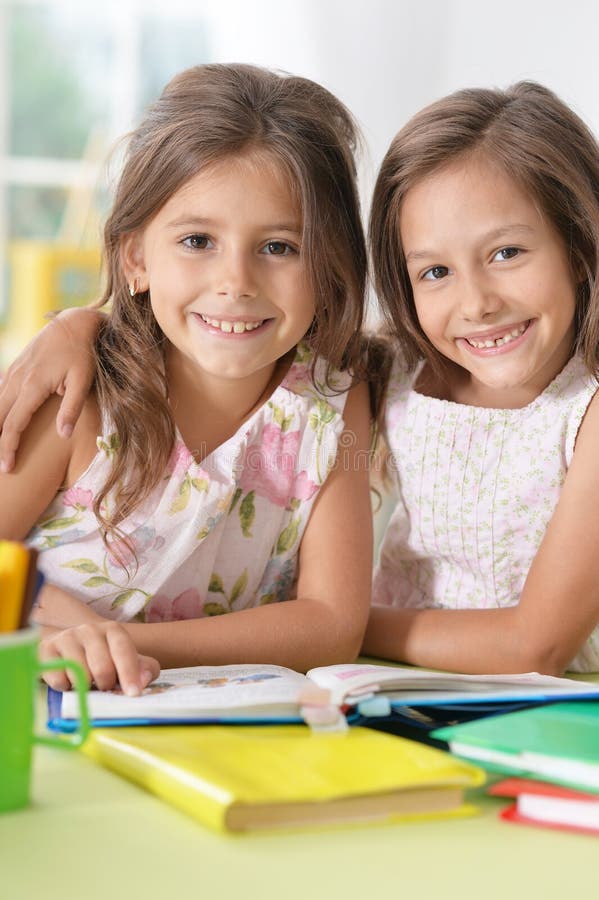 Portrait of Two Beautiful Little Girls Studying Stock Image - Image of ...