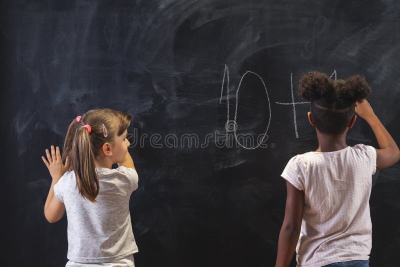 Two Schoolgirls Doing Math on Chalkboard in Classroom Stock Image ...