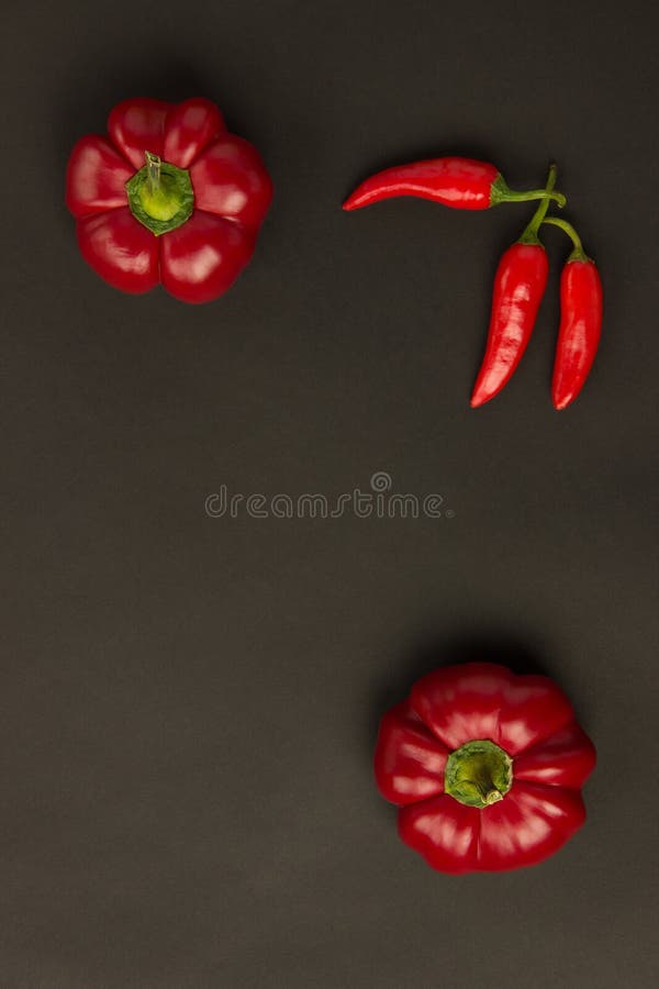 Two Beautiful Red Peppers and Three Hot Peppers on a Black Background ...