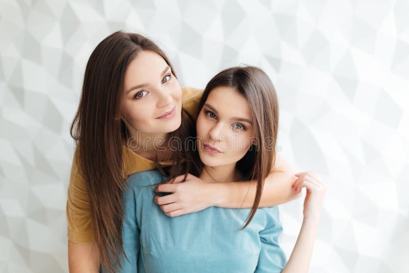 Two Beautiful Sisters Twins Standing and Hugging Together Stock Photo ...