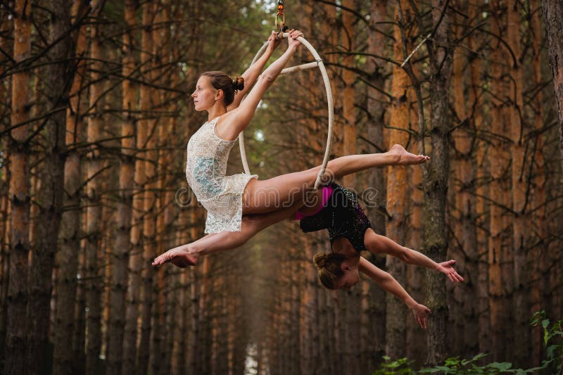 Two Beautiful Teen Gymnasts Doing Exercises at the Air Ring in the ...