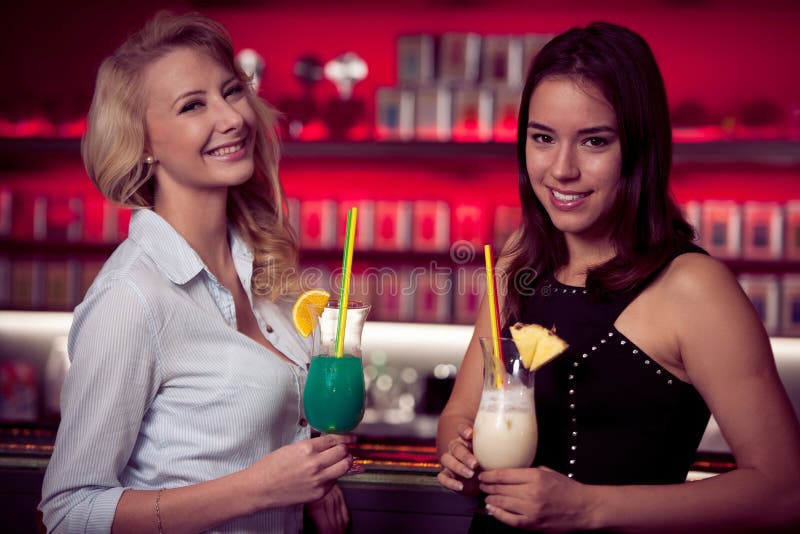Two Beautiful Women Drinking Cocktail in a Night Club and Having Stock ...