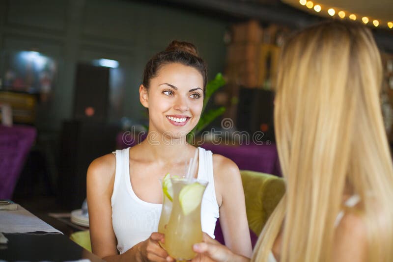 Two Beautiful Women Drinking Cocktails Stock Image - Image of cocktail ...