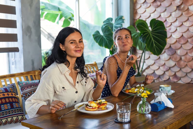 Two Beautiful Women Friends Eating Breakfast in Cafe and Talking Stock ...