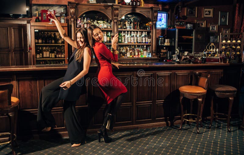 Two Beautiful Women Having Fun at the Bar Stock Photo - Image of glass ...