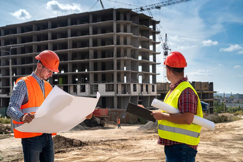 Two Beautiful Workers in Uniform on a Construction Site are Considering ...