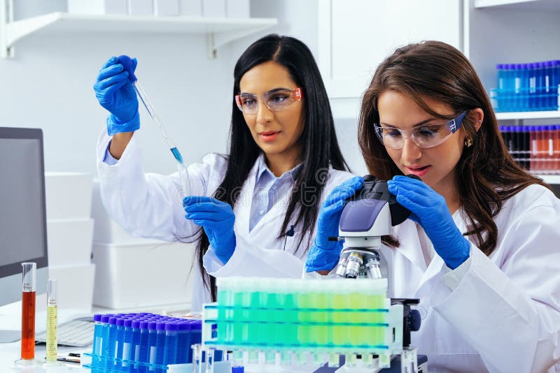 Two Beautiful Young Female Scientists Working in Laboratory with Test ...