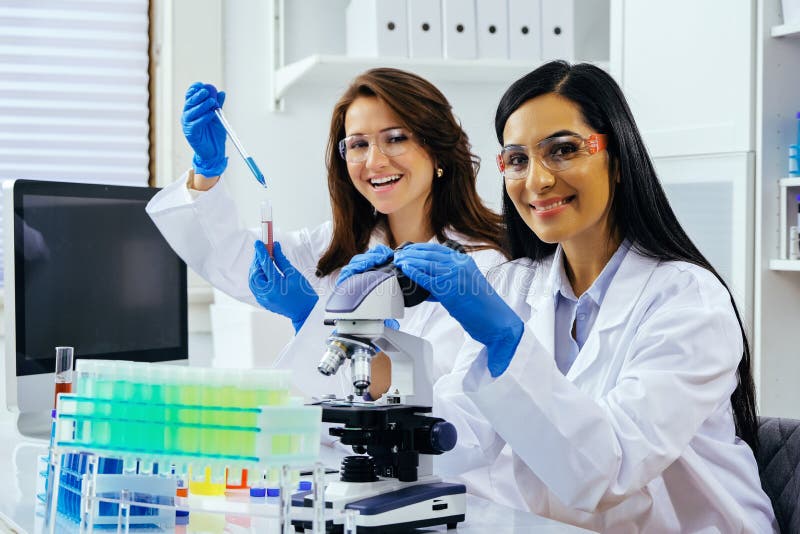 Two Beautiful Young Female Scientists Working in Laboratory with Test ...
