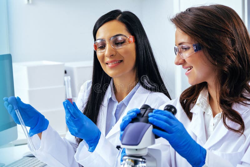 Two Beautiful Young Female Scientists Working in Laboratory with Test ...