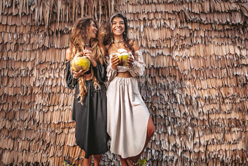 Two Beautiful Young Stylish Fashion Models Having Fun with Coconuts ...