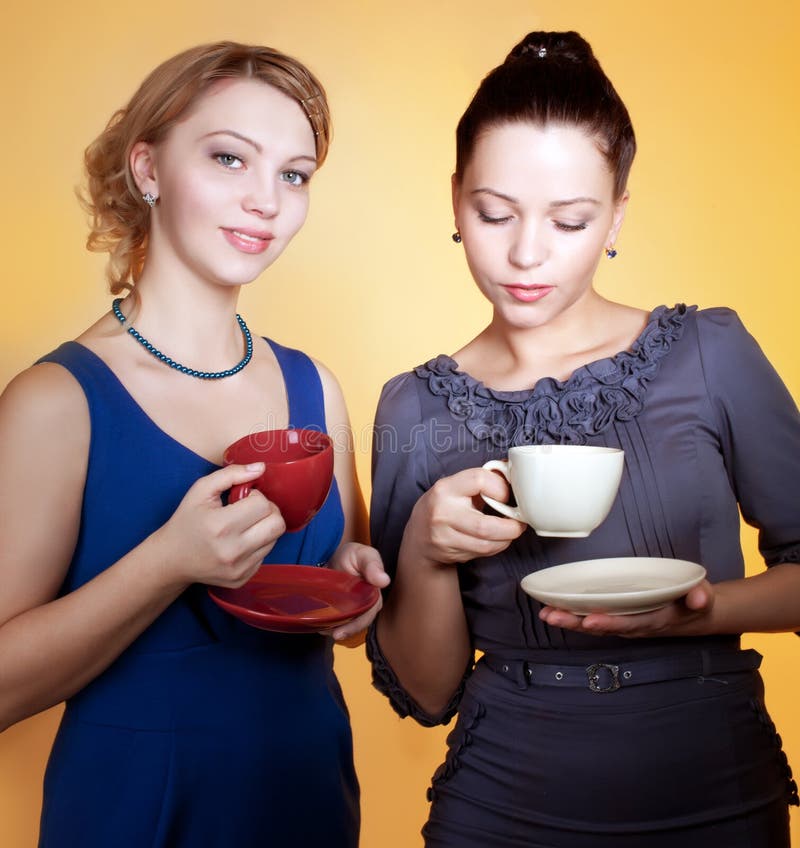 Two Beautiful Young Women Drinking Coffee or Tea Stock Image - Image of ...