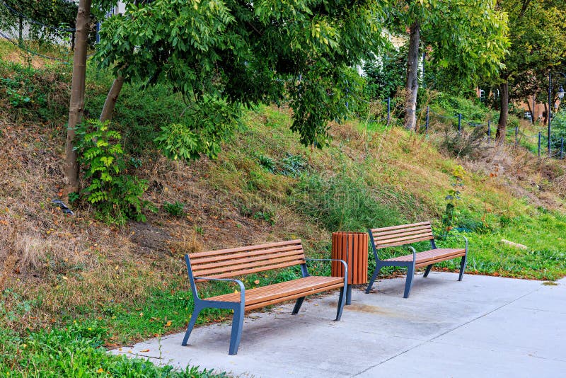 Two Benches and a Trash Bin on a Path in the Park Stock Photo - Image ...