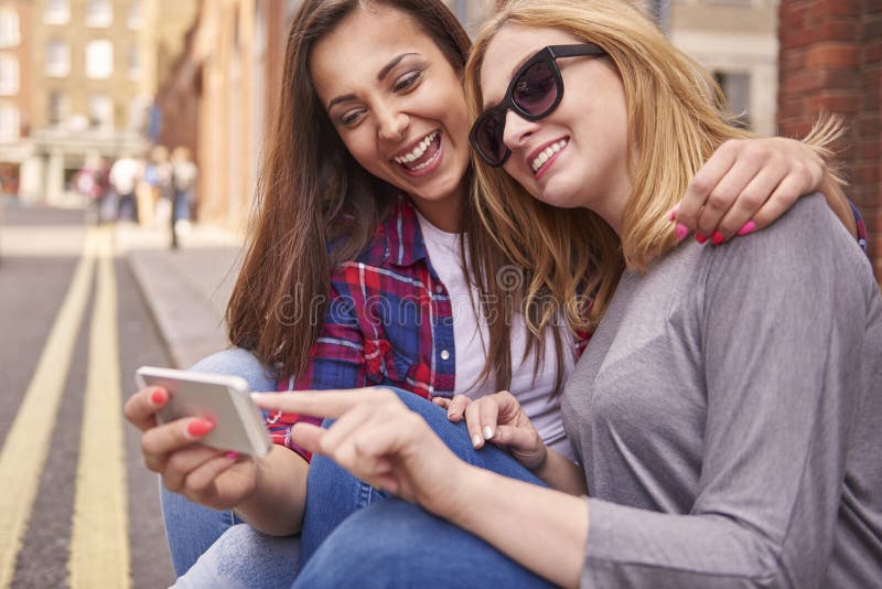 Two Best Friends with Mobile Phone Stock Photo - Image of pavement ...